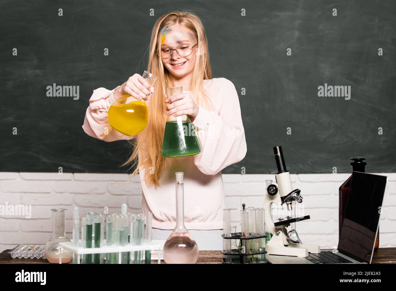 Funny little school child doing experiments in the laboratory. Science ...