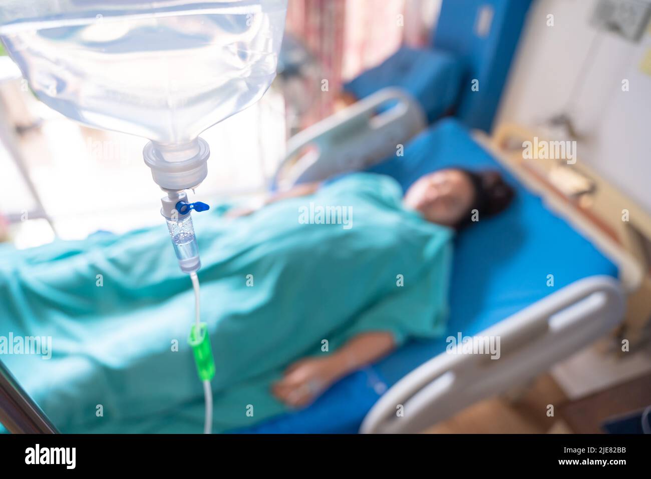 Asian Pregnant Woman patient is on drip receiving a saline solution on ...