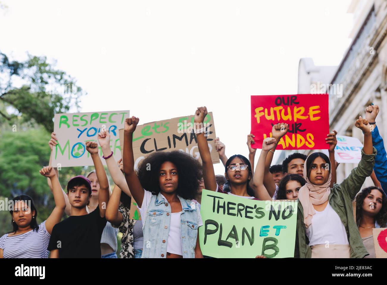 Diverse young people standing up against global warming. Group of ...