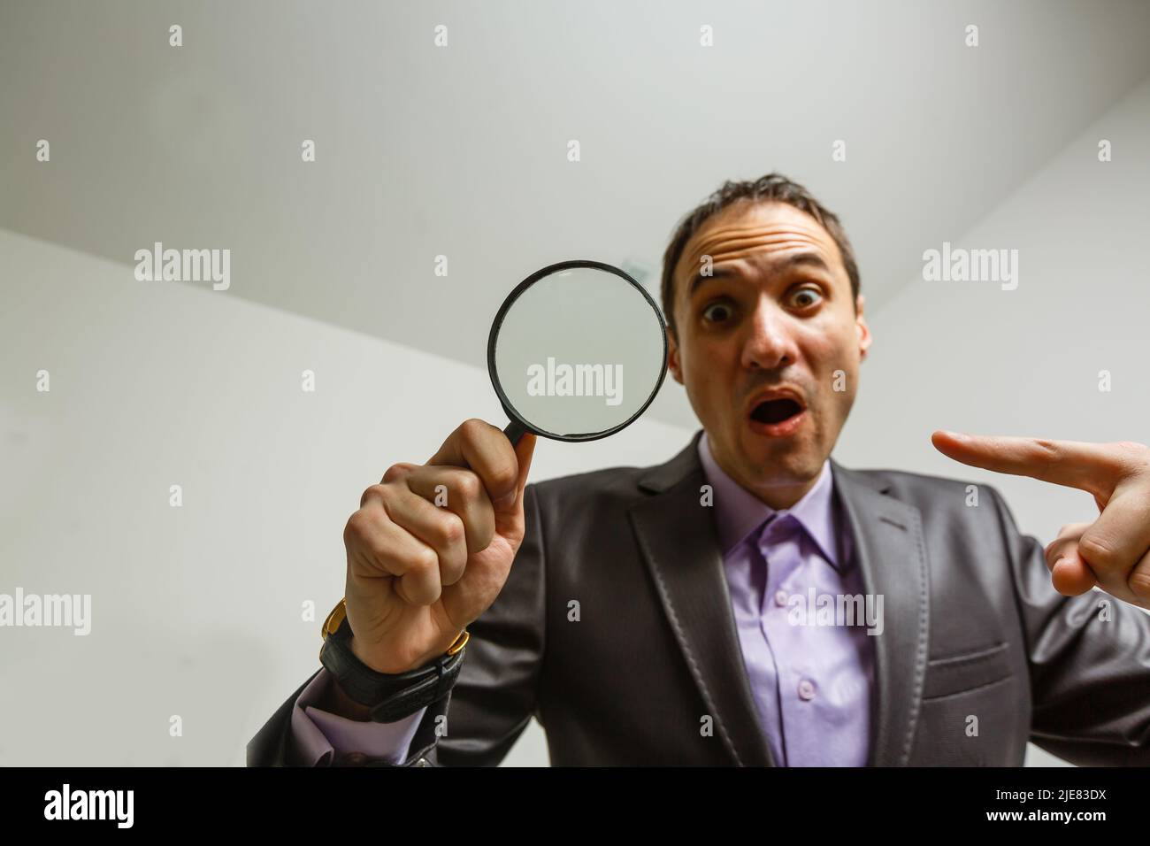 Man hand holding magnifying glass. Data search and analysis, conducting research, nuances ...