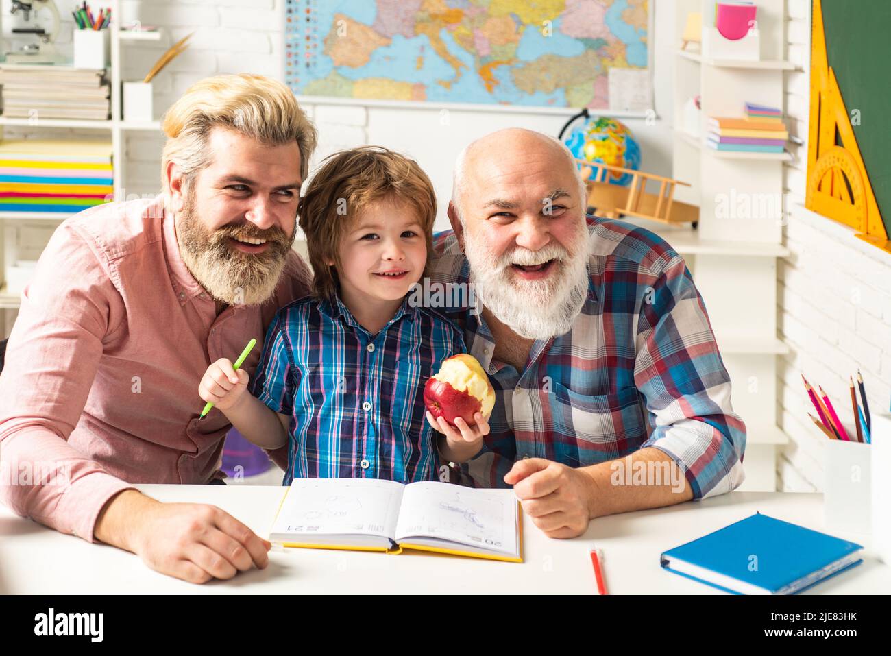Happy grandfather father and son. Grandpa teaching grangson at home ...