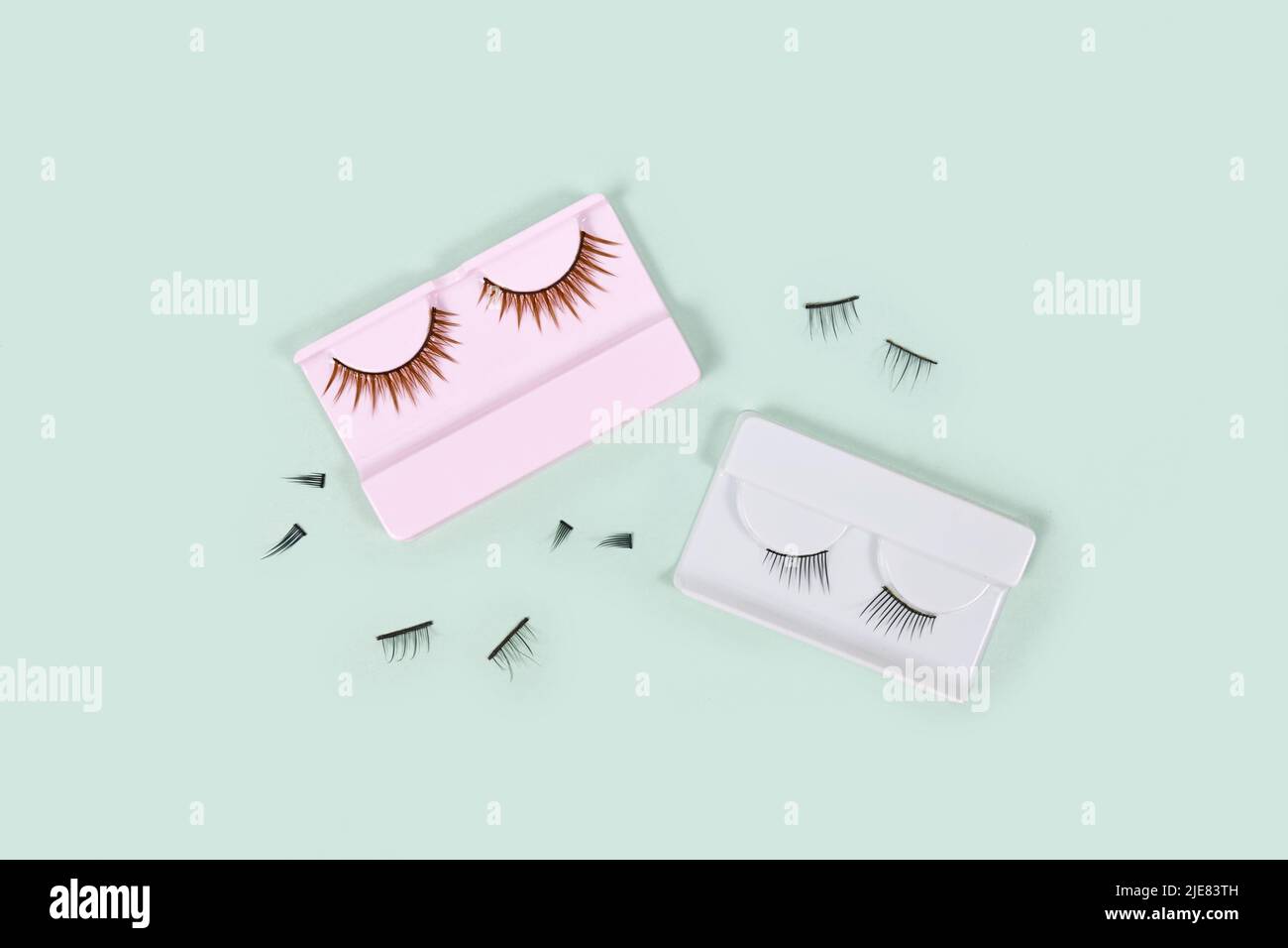 Different false lashes on mint green background Stock Photo - Alamy