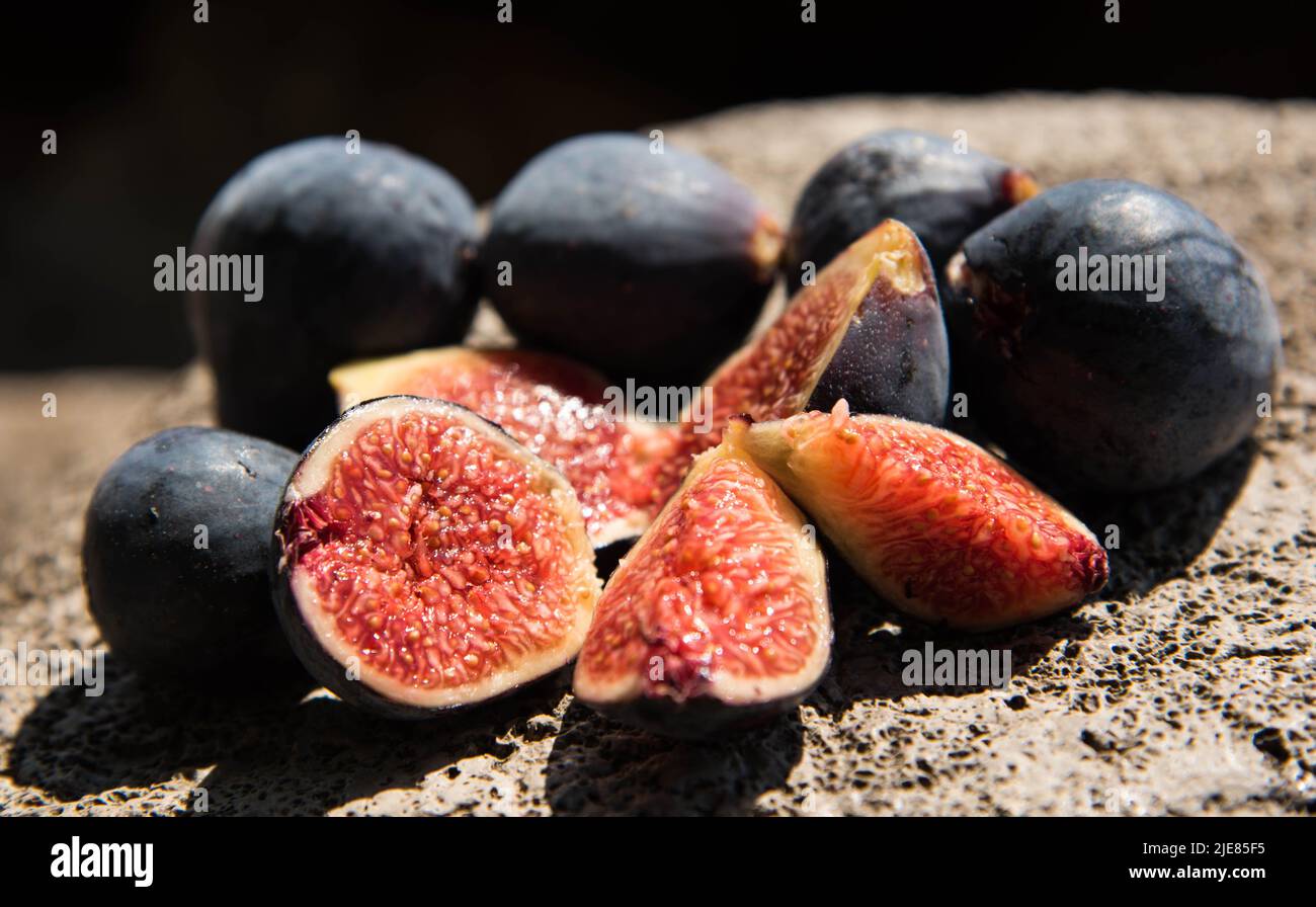 Figs cut into pieces lie on a stone. High quality photo Stock Photo - Alamy