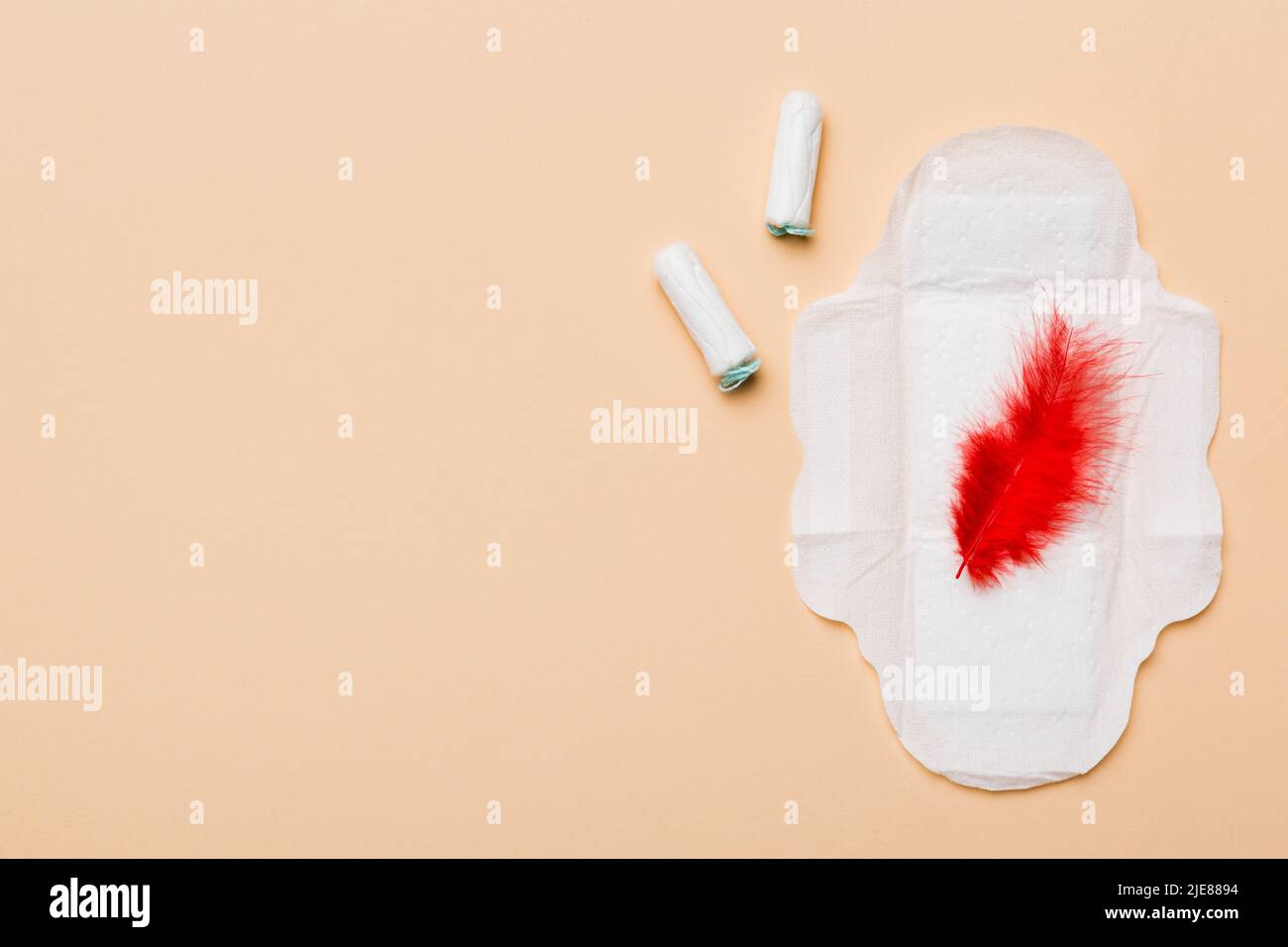 women pads and tampon - sanitary pads lies next to a tampon on an ...