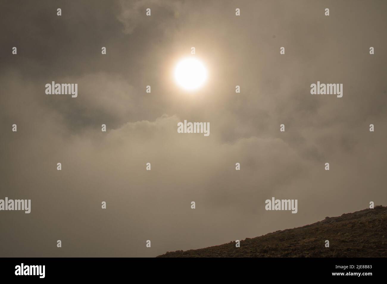 The view of the sun seeing through dense fog and clouds Stock Photo - Alamy
