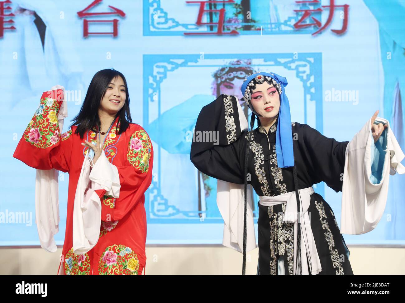 QINGDAO, CHINA - JUNE 25, 2022 - A Chinese opera teacher instructs ...