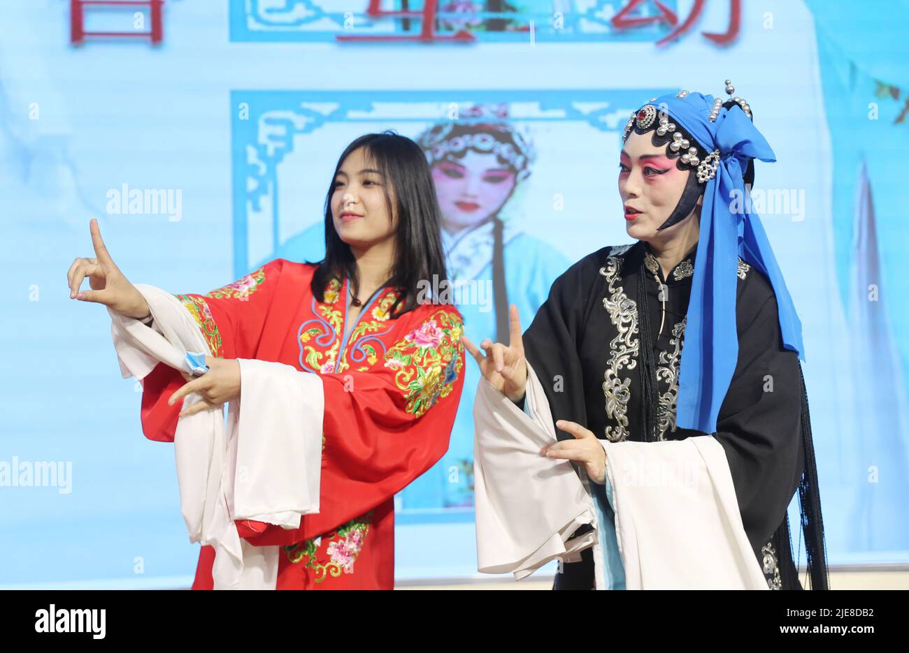 QINGDAO, CHINA - JUNE 25, 2022 - A Chinese opera teacher instructs ...