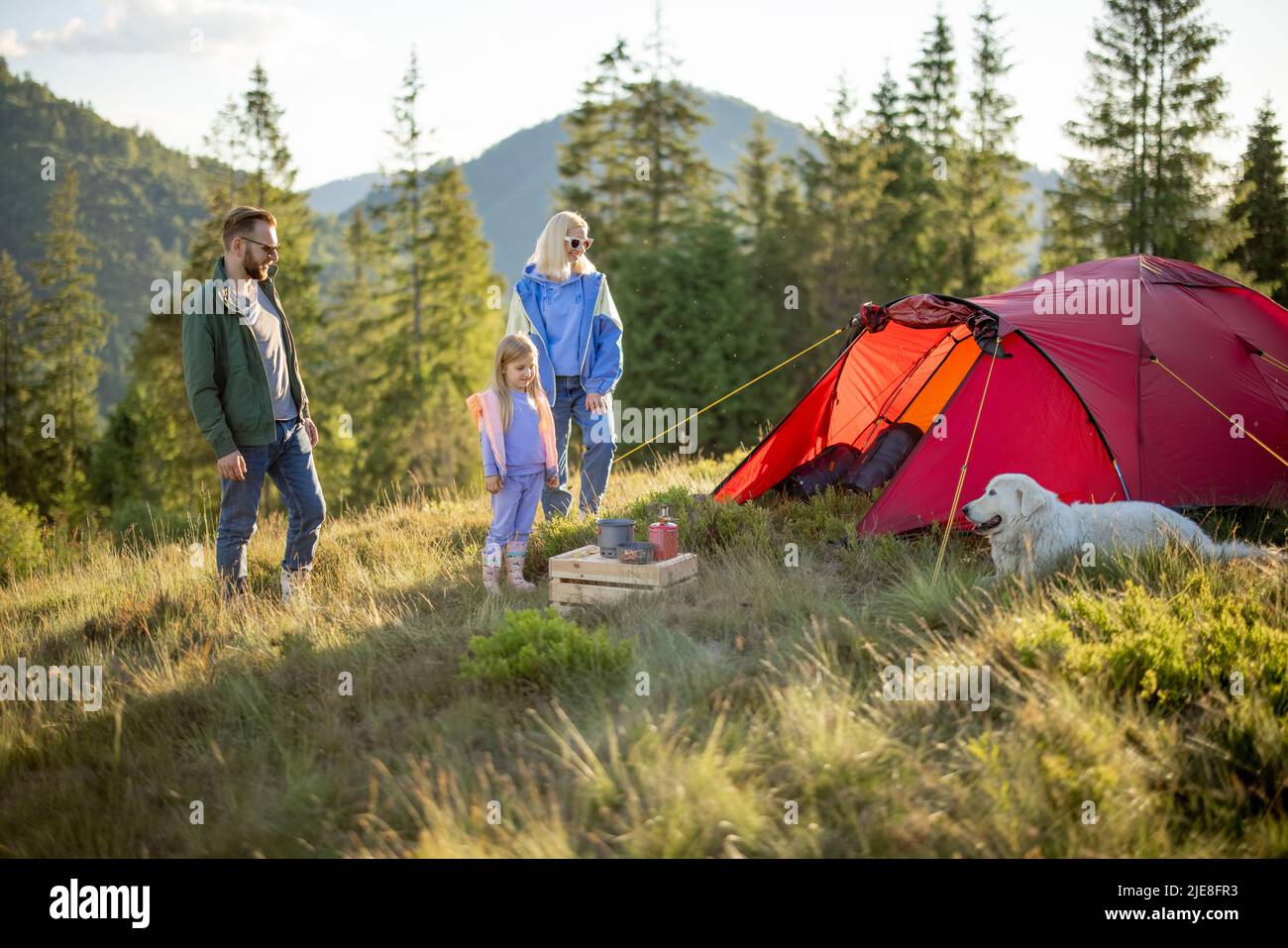 Happy family with little girl travel in the mountains Stock Photo - Alamy