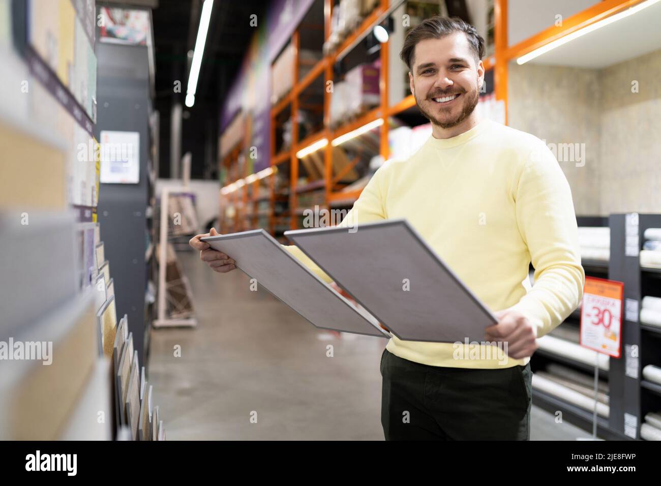 the buyer in the store examines samples of finishing materials for ...