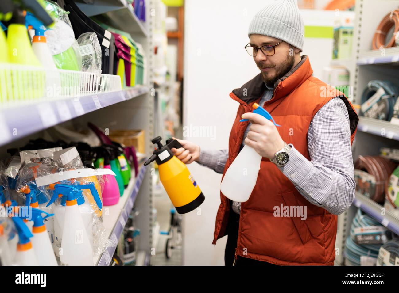 the buyer in the store chooses a spray bottle Stock Photo - Alamy