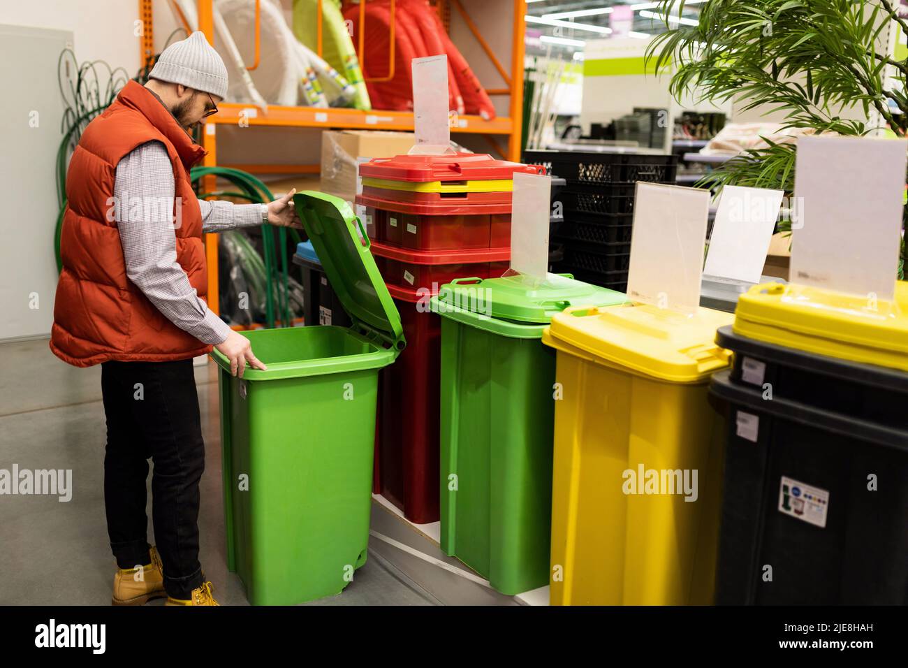 a man chooses a bin for sorting garbage and household waste Stock Photo ...
