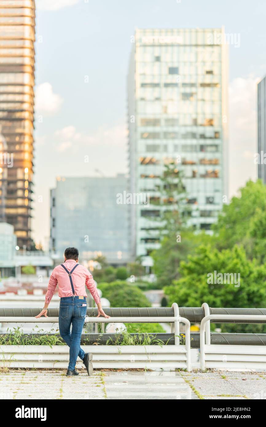 Back of a man looking the urban landscape from viewpoint Stock Photo ...