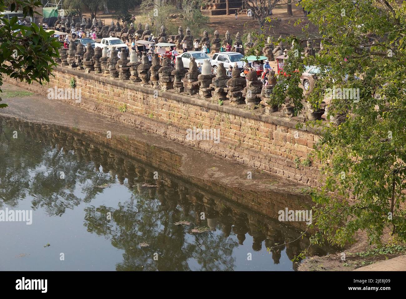 Tourists are gettin in Angkor Thom from South gate with a row of asuras ...