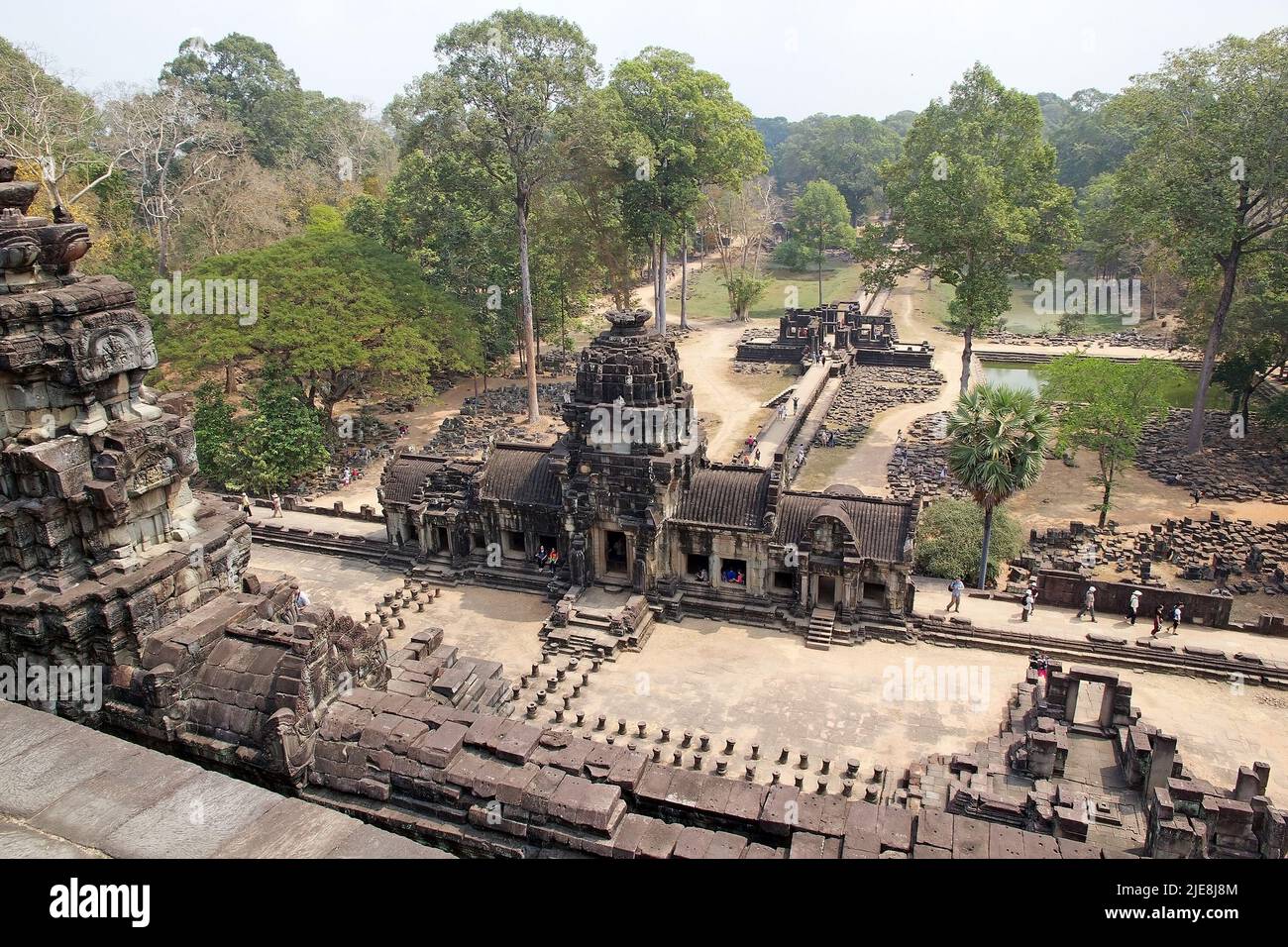 Tourist are visiting the Baphuon temple. View from the upper terrace ...