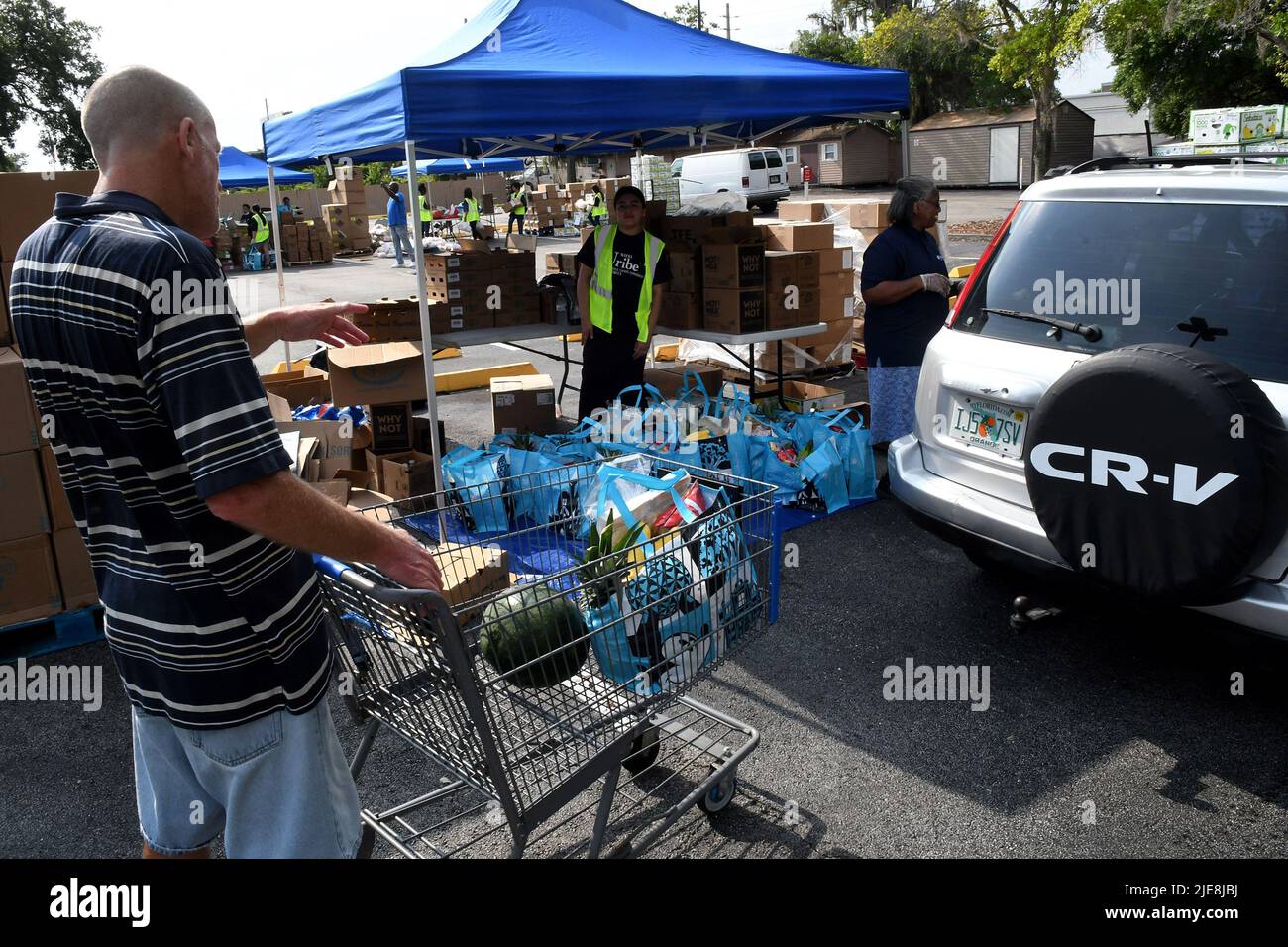 Orlando, United States. 25th June, 2022. A man receives food items in a ...