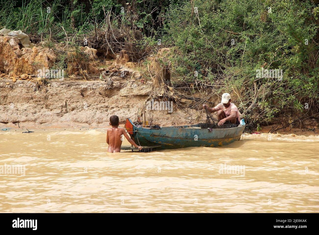 Fishermen with traditional boats on the Tonle Sap lake, Cambodia. Tonle ...