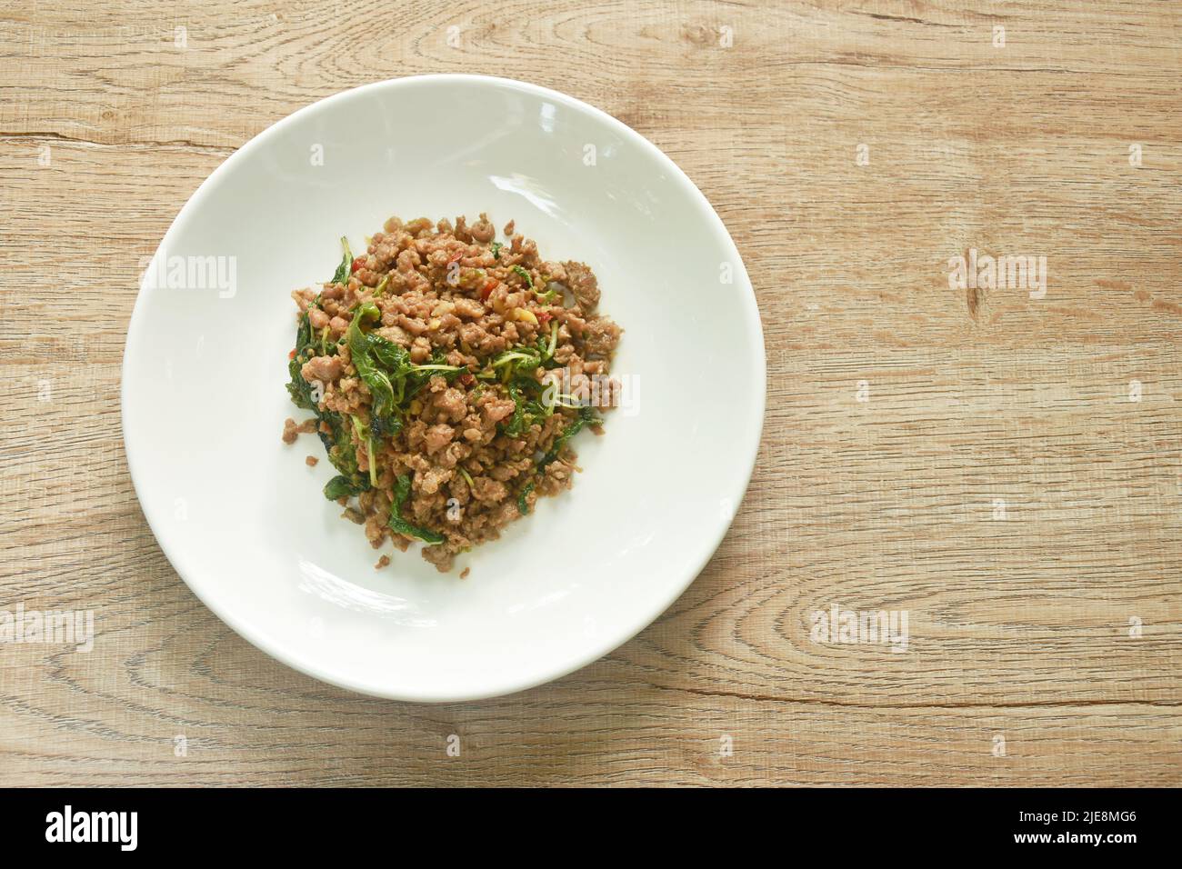 spicy stir fried chop pork with chili and basil leaf on plate Stock ...