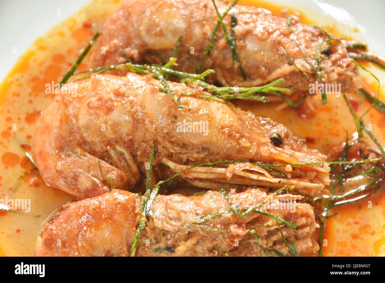 spicy stir fried river shrimp with slice grass leaf curry on plate ...