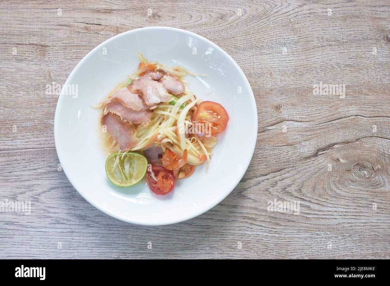 Som tum Thai spicy green papaya topping slice barbecue pork salad on ...