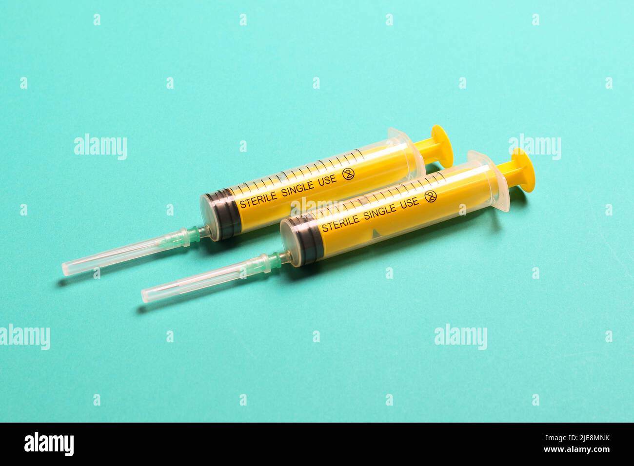 Top view of syringes in a row for medical injection on colorful ...