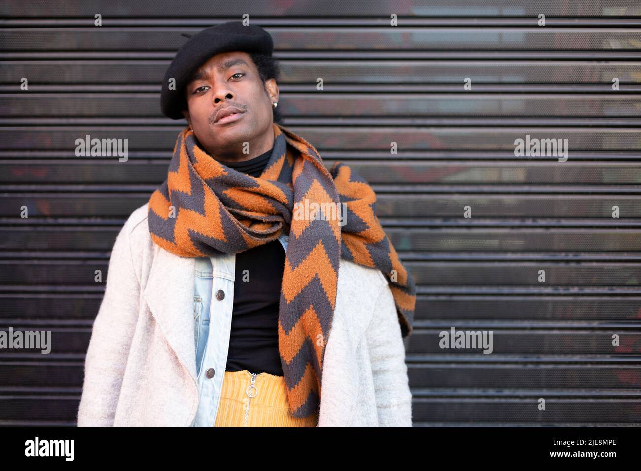 Outdoor portrait of young adult african american man looking at camera ...