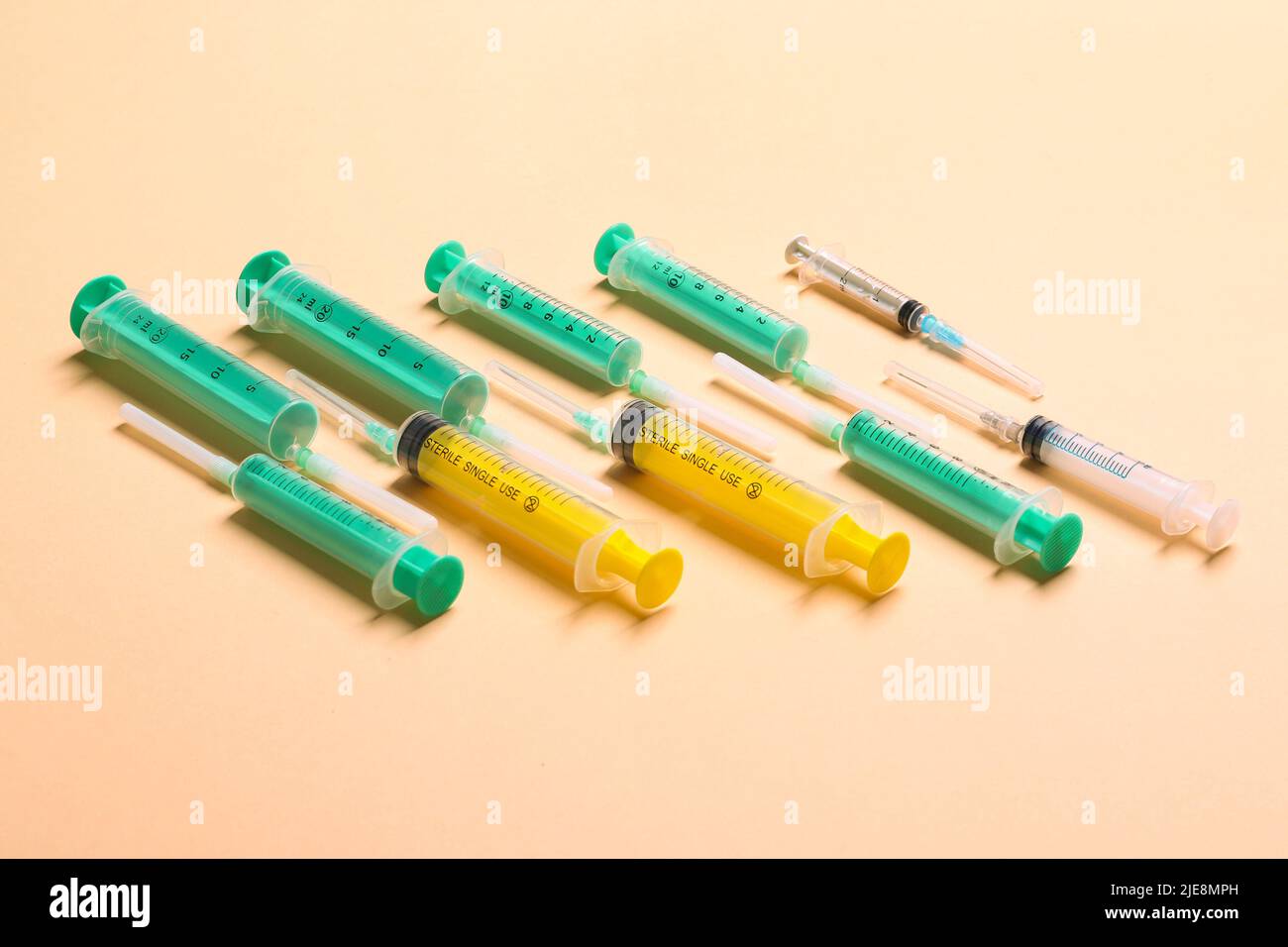 Top view of different syringes at orange background. Medical injection ...