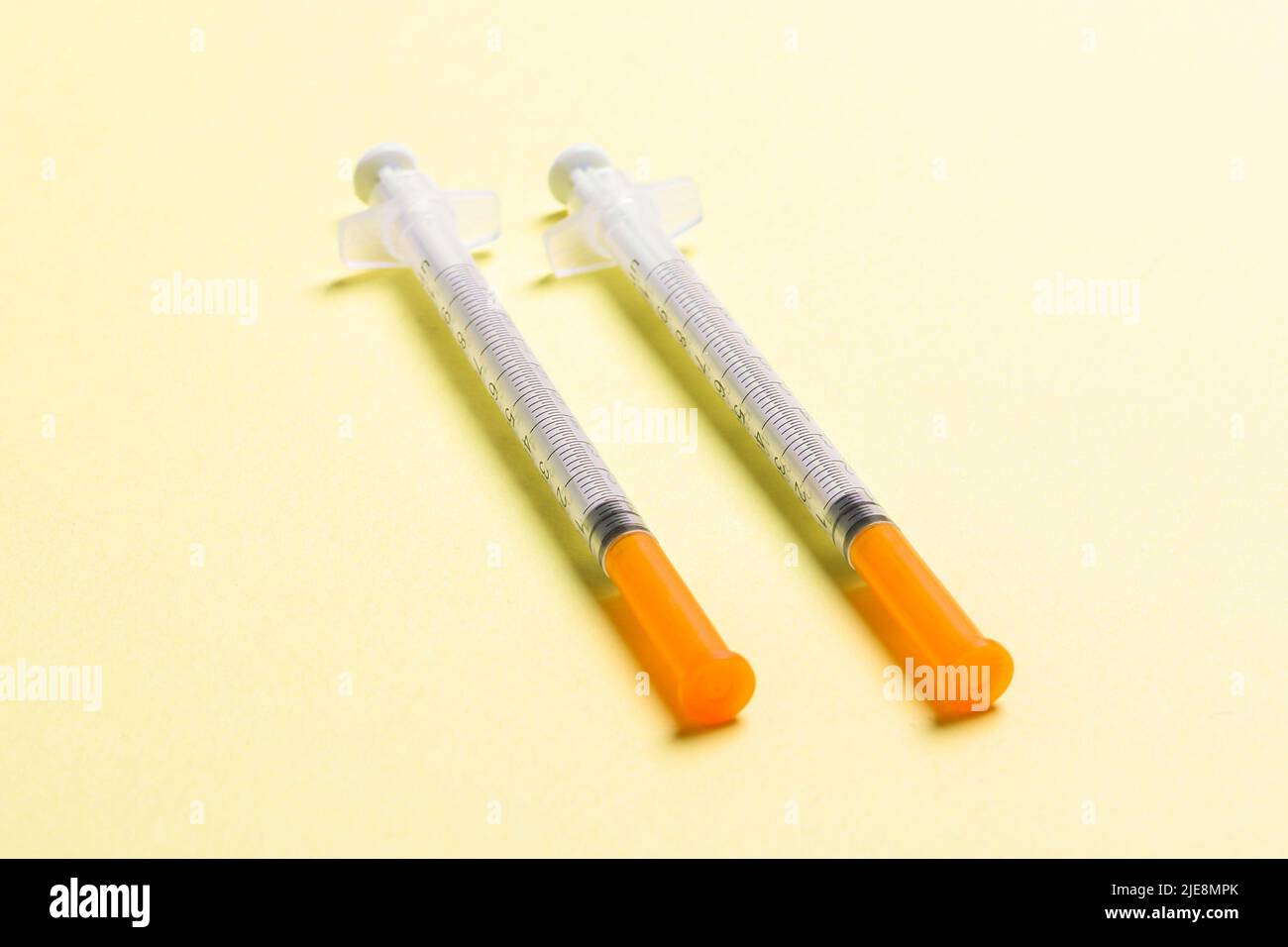 Top view of insulin syringes ready for injection on colorful background ...