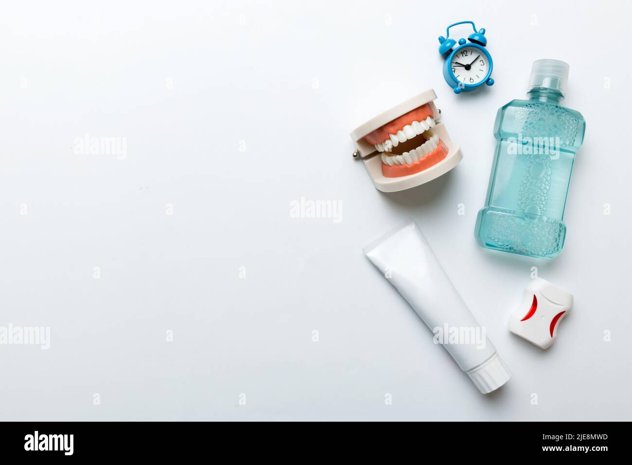 Mouthwash and other oral hygiene products on colored table top view ...