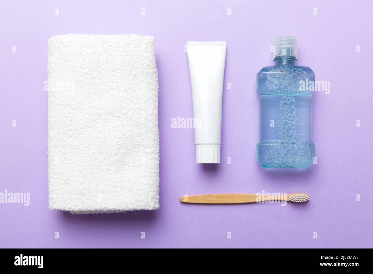 Mouthwash and other oral hygiene products on colored table top view ...