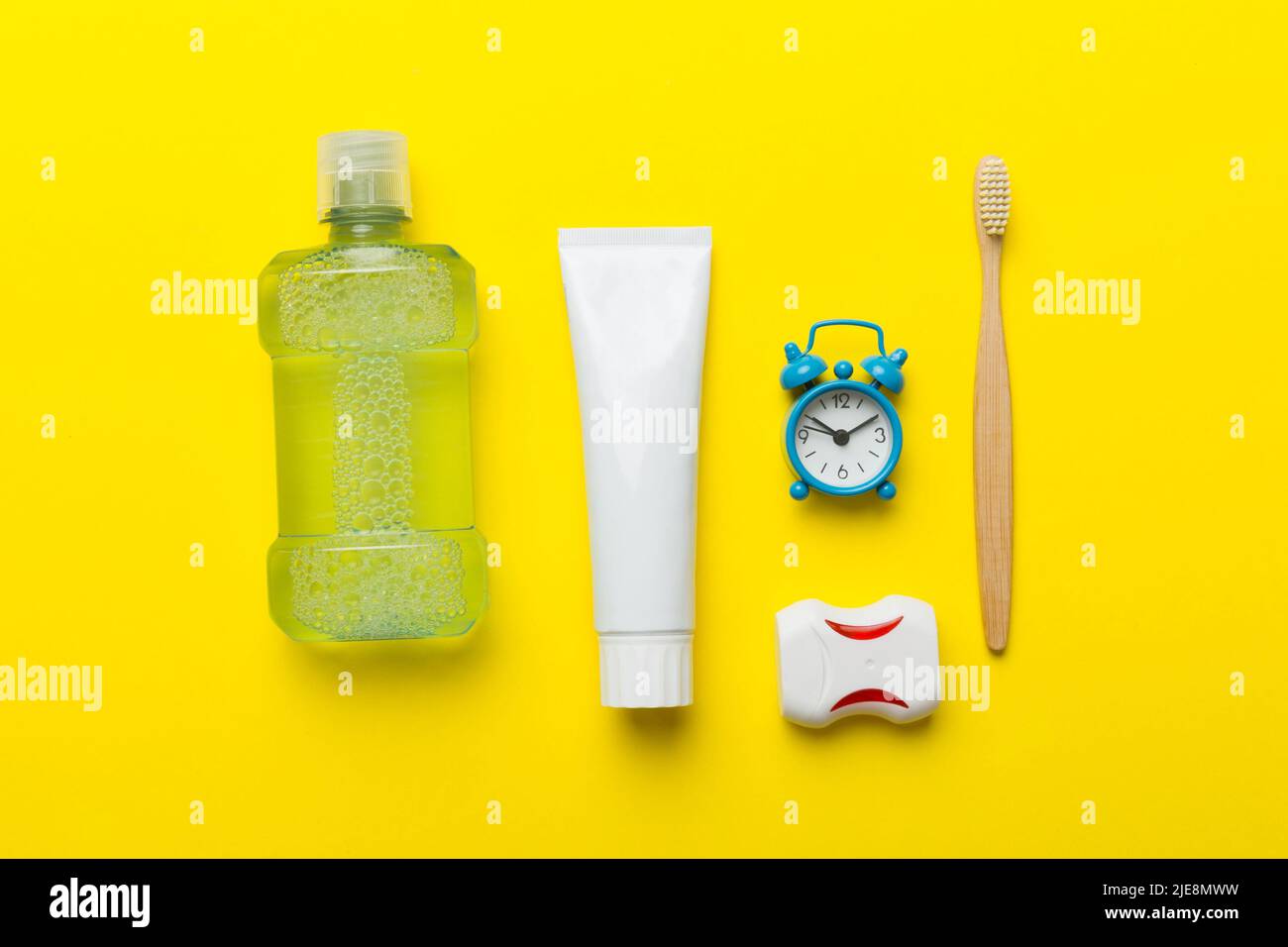 Mouthwash and other oral hygiene products on colored table top view ...