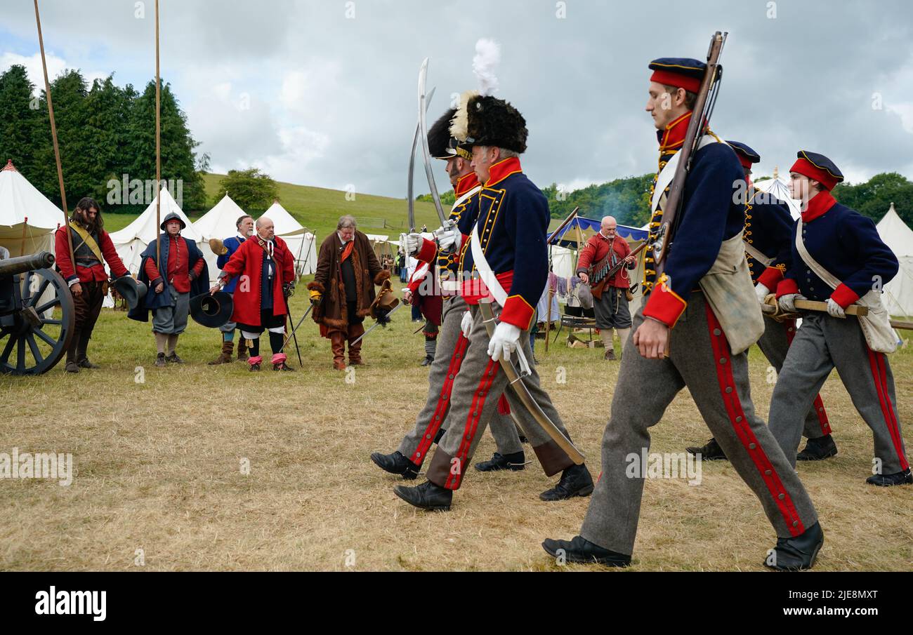 Members of the Devereaux's Regiment (left) perform a salute as members ...