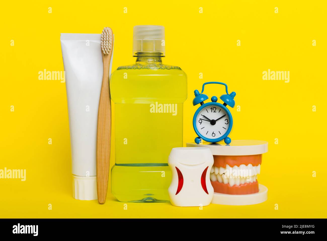Mouthwash and other oral hygiene products on colored table top view ...