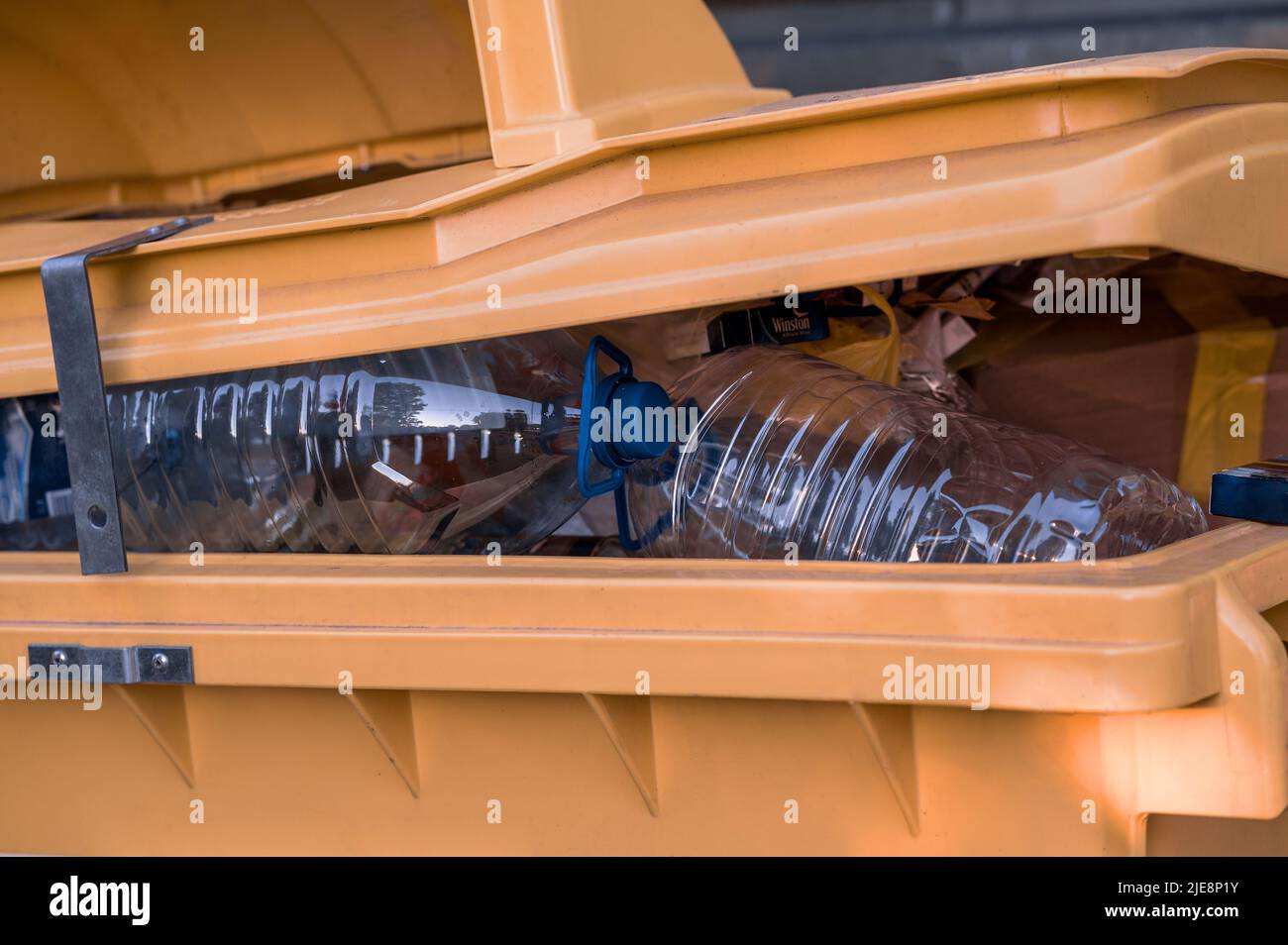 Overflowing yellow container for plastic waste. Waste sorting Stock ...