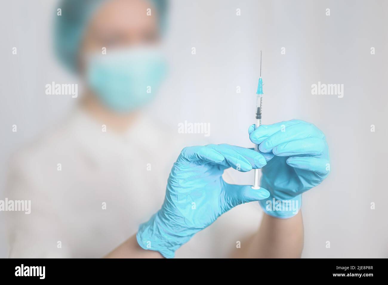 hands of a female doctor in blue nitrile gloves for protection holds a ...