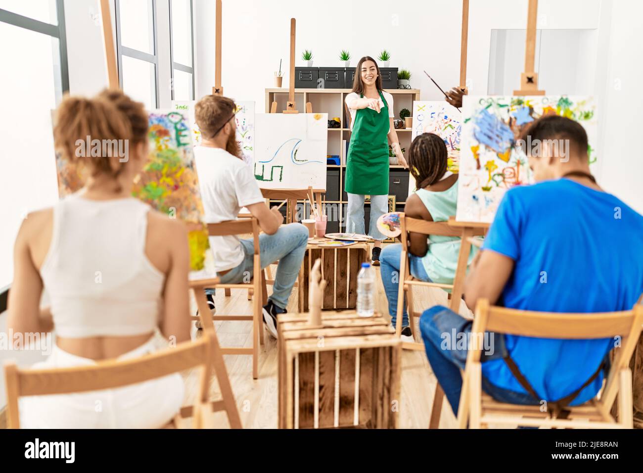 Group of people smiling happy drawing in paint class at art studio ...