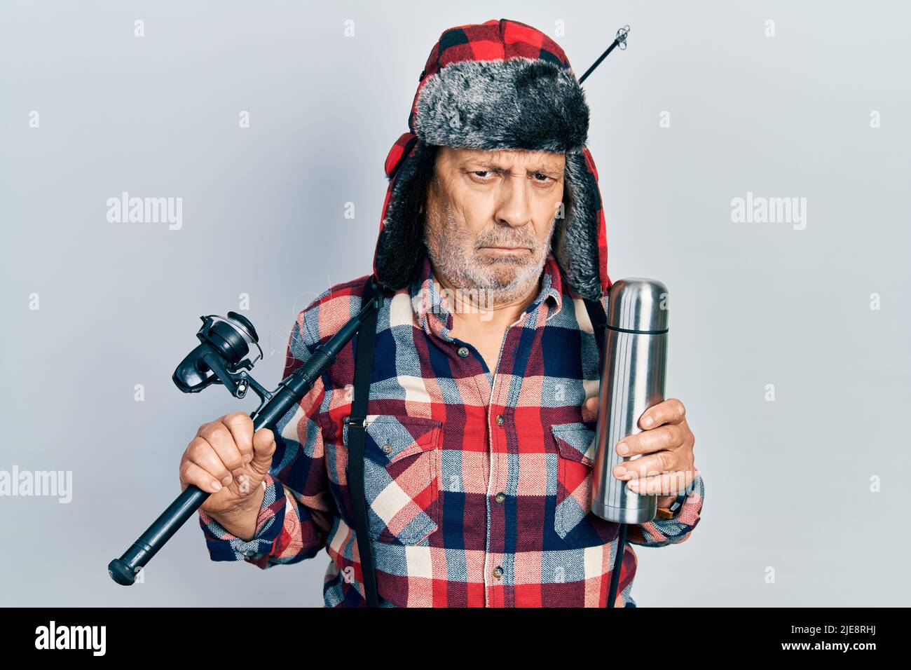 Handsome mature man wearing fisherman equipment and thermo skeptic and ...