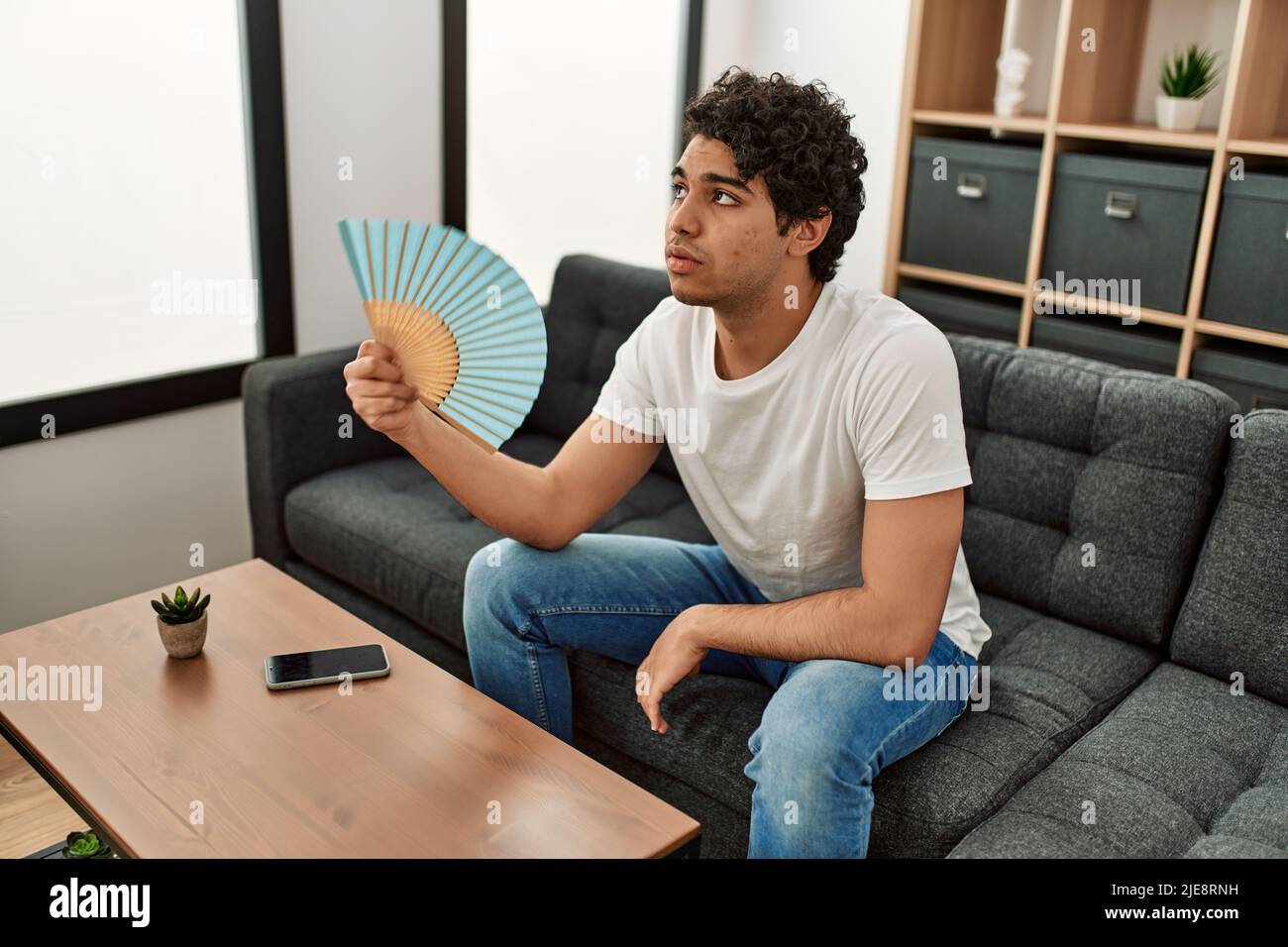 Man holding fan to cool the face hi-res stock photography and images ...