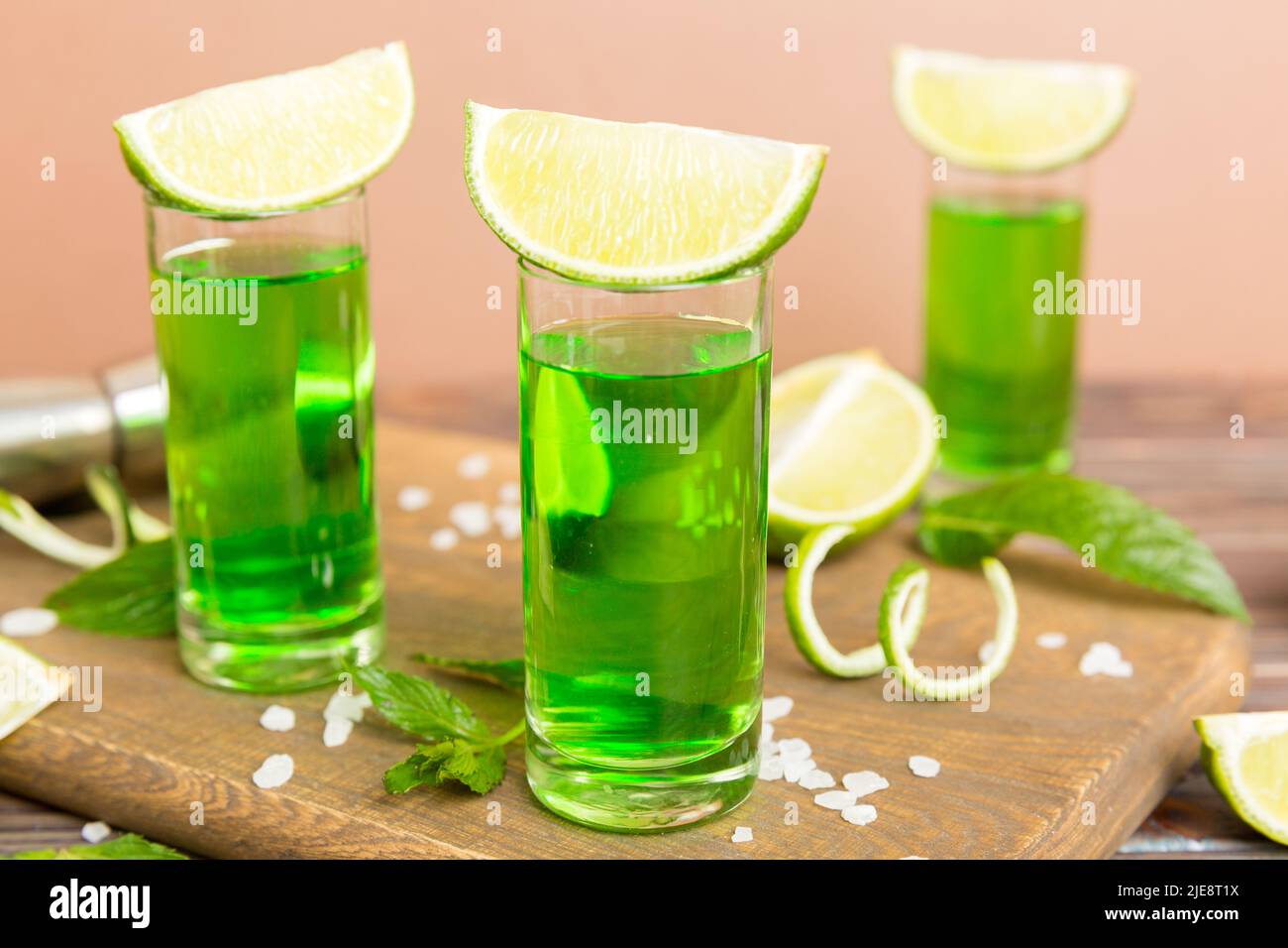 Sweet refreshing mint liqueur, with ice and mint leaves on table ...