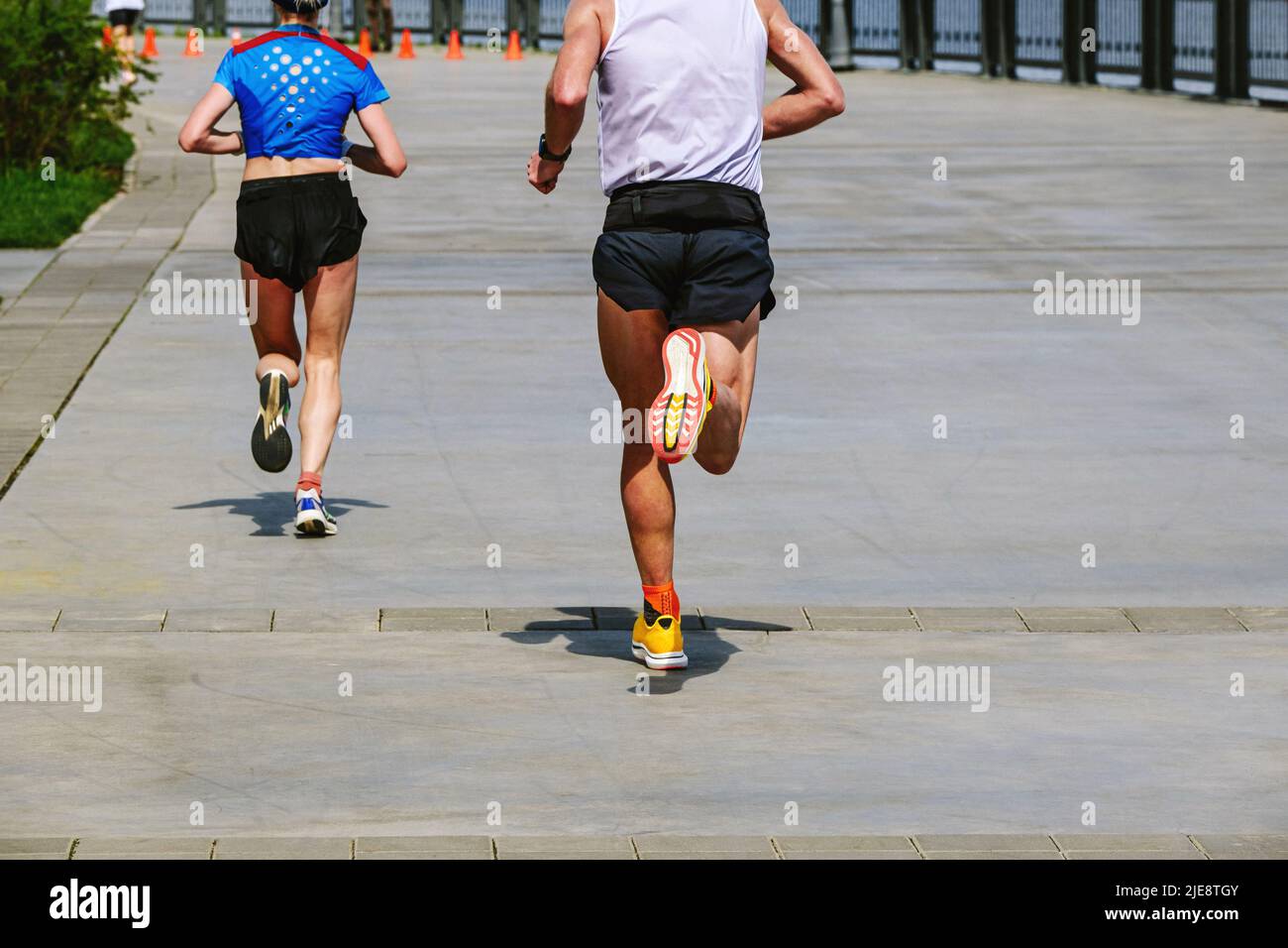 man and woman runners run marathon in riverfront Stock Photo - Alamy