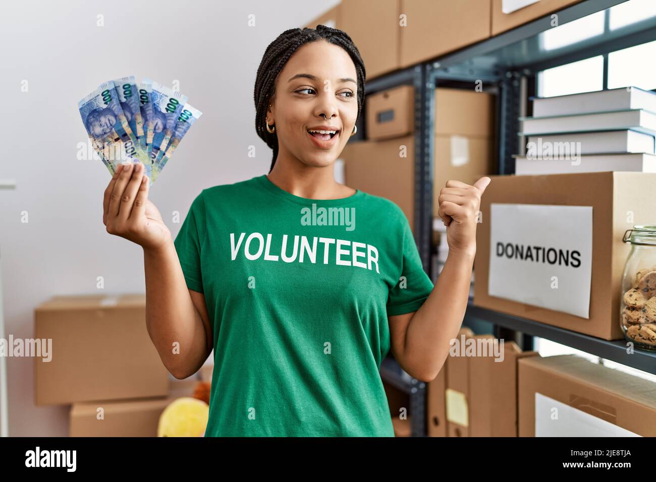 Young african american woman wearing volunteer t shirt holding african ...