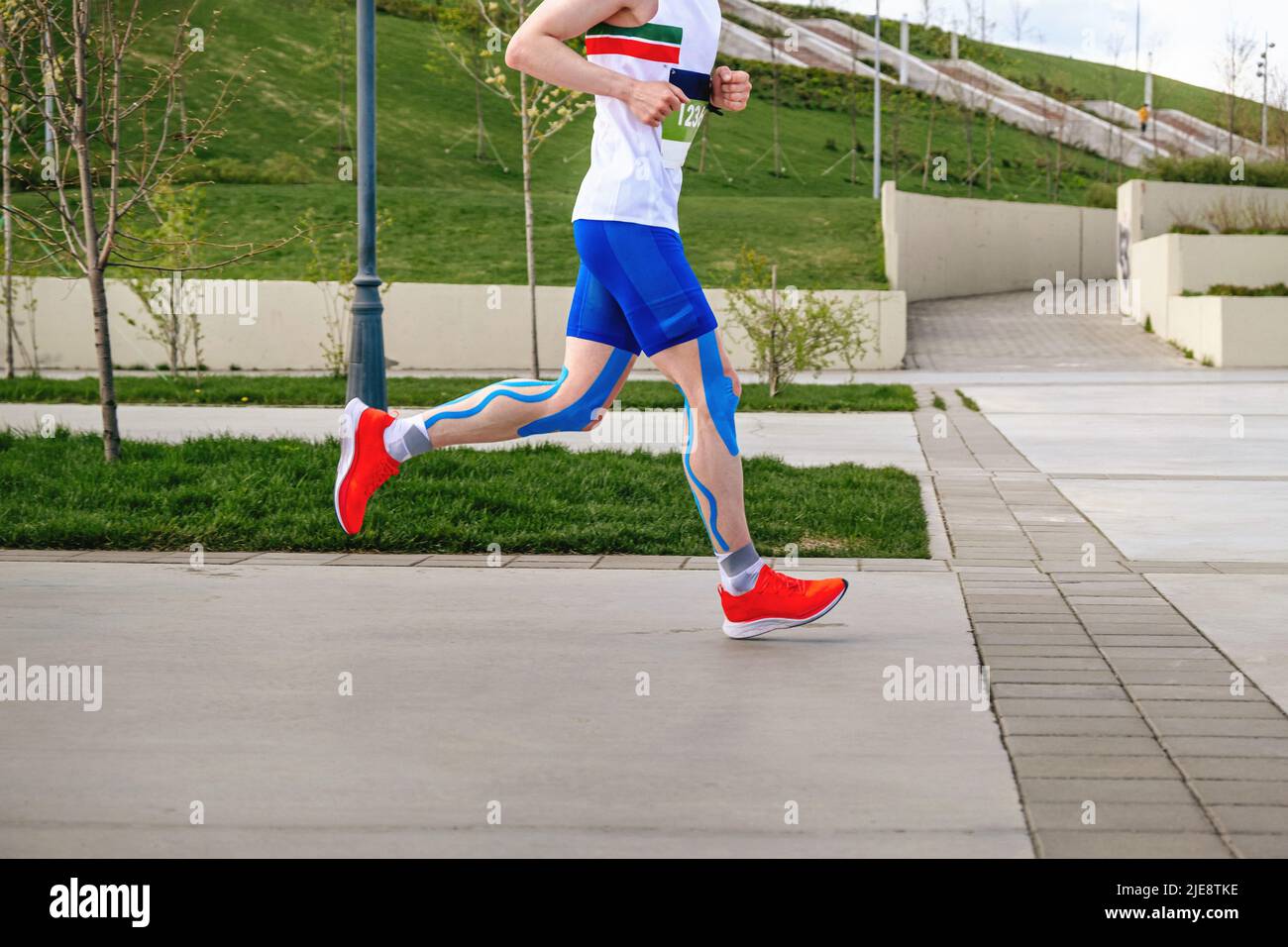 athlete runner on legs kinesio taping running marathon Stock Photo - Alamy
