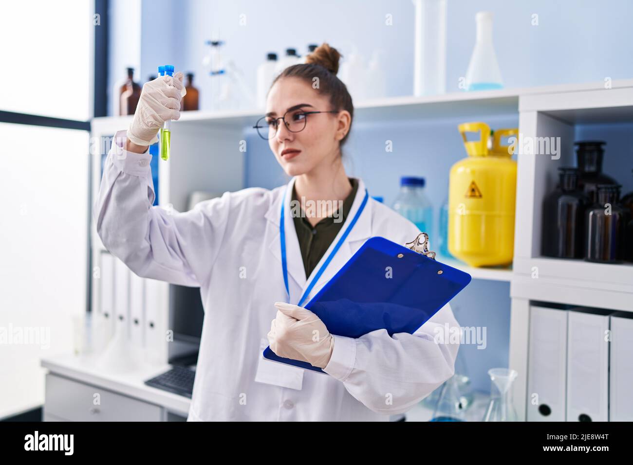 Young woman scientist measuring liquid at laboratory Stock Photo - Alamy
