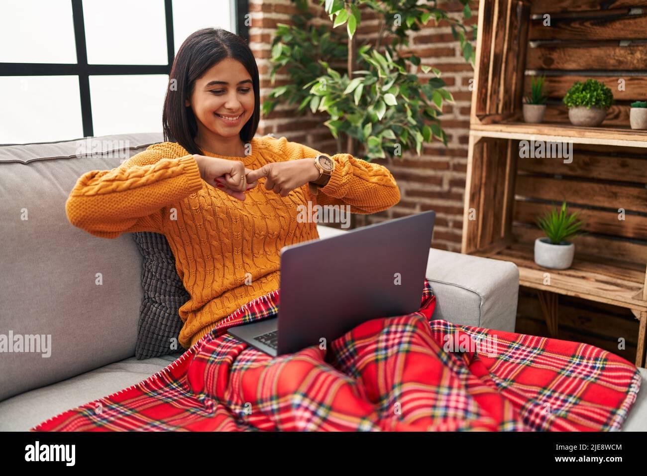 Young latin woman having video call using deaf sign language at home ...