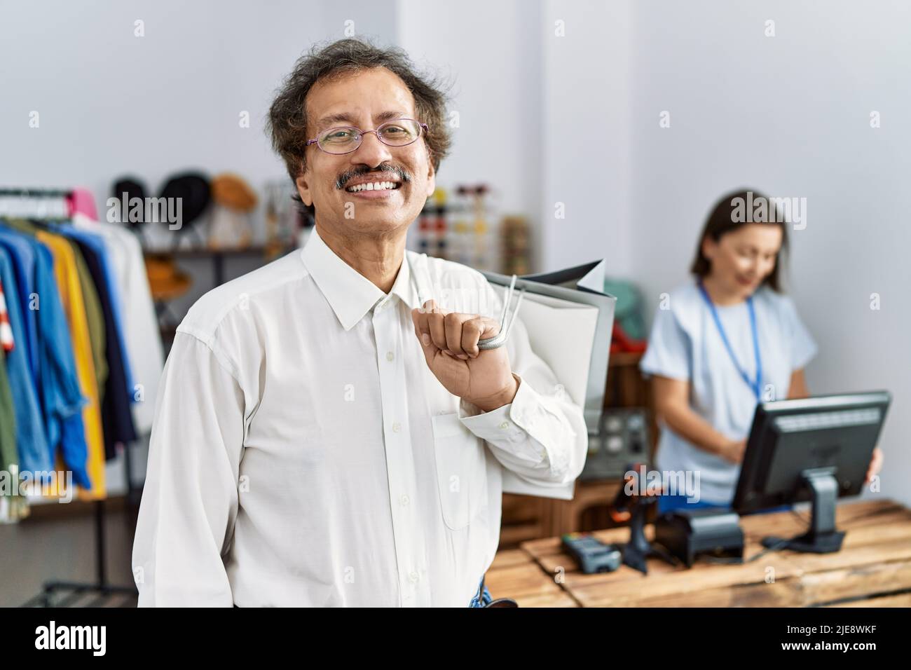 Southeast asian man wearing holding shopping bags looking positive and ...