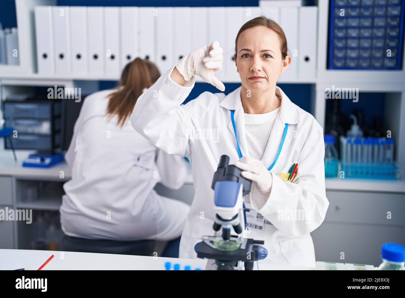 Blonde woman working on cruelty free laboratory with angry face ...