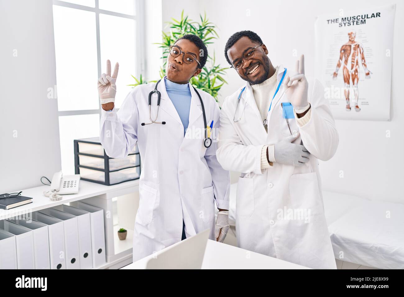 Young african american doctors working at medical clinic smiling with ...