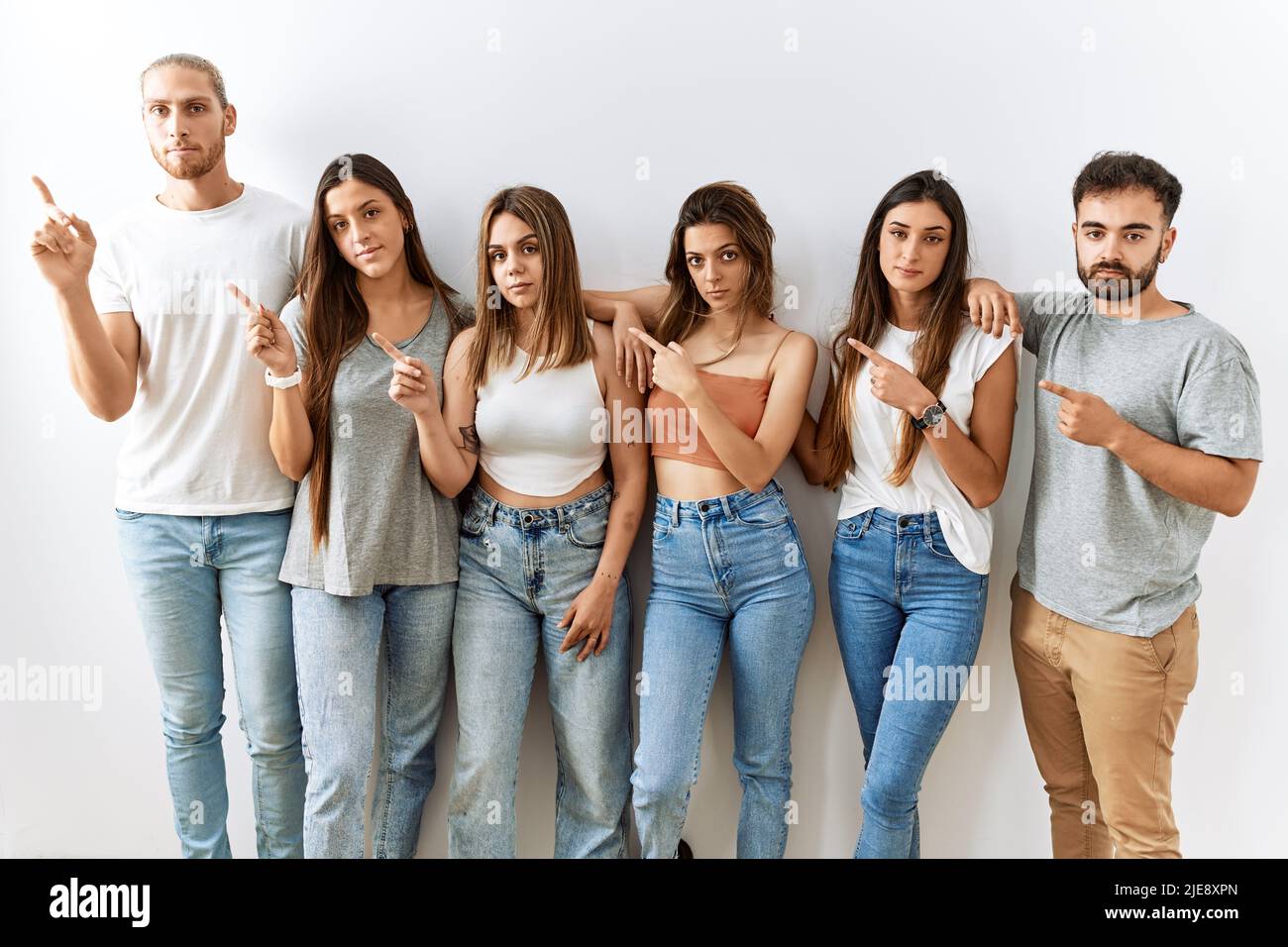 Group of young friends standing together over isolated background ...