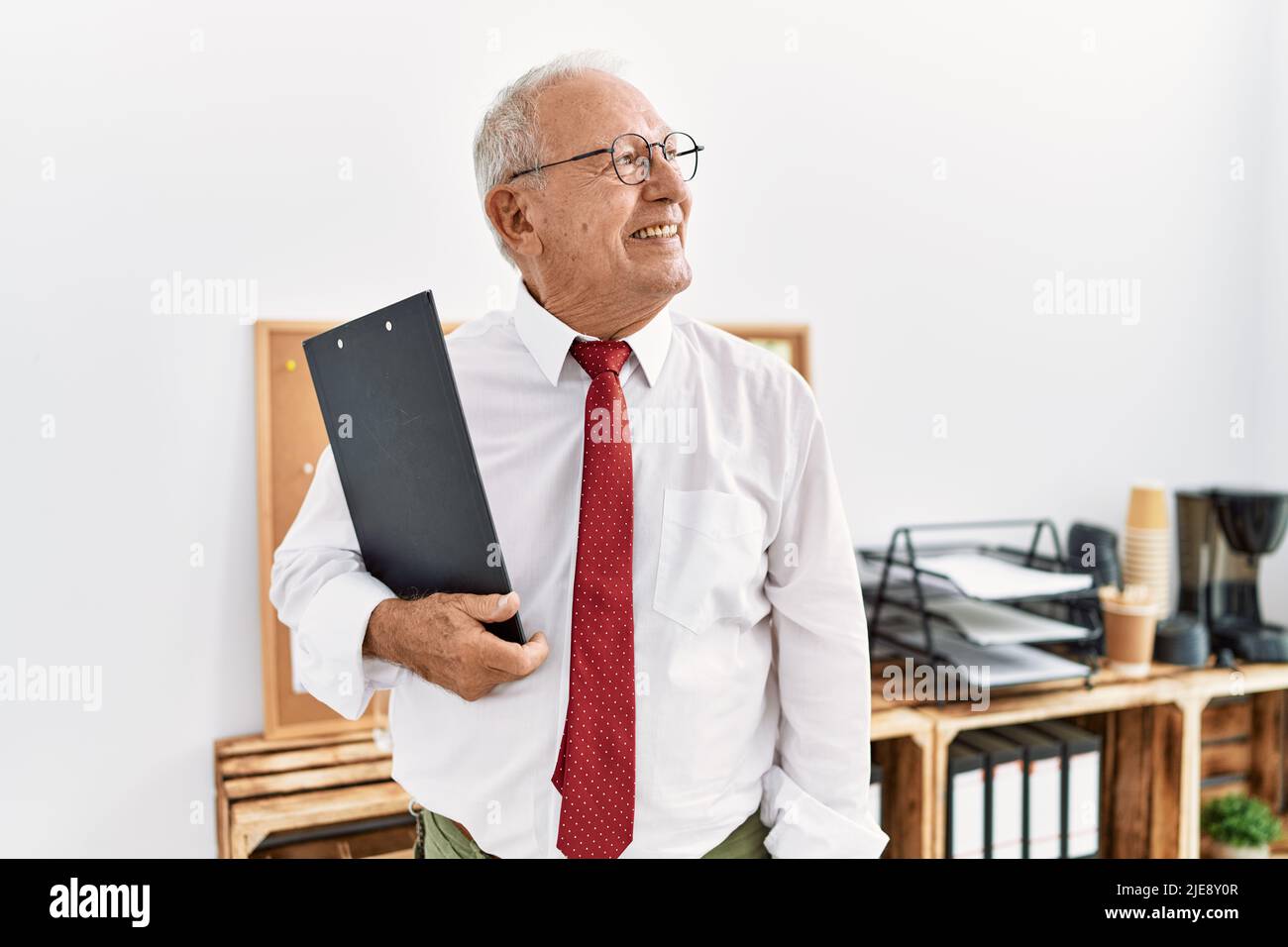 Senior man business worker holding clipboard at office Stock Photo - Alamy