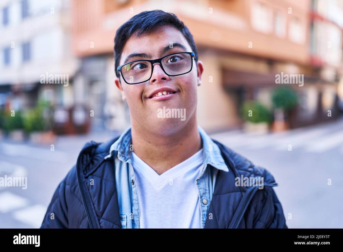 Down syndrome man smiling confident standing at street Stock Photo - Alamy