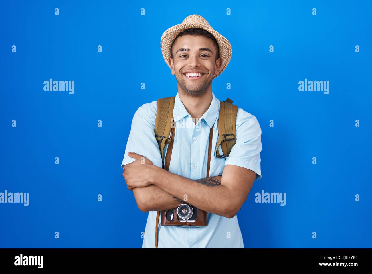 Brazilian young man holding vintage camera happy face smiling with ...